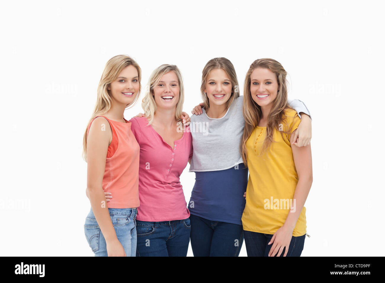 Four friends standing beside each other and smiling Stock Photo - Alamy