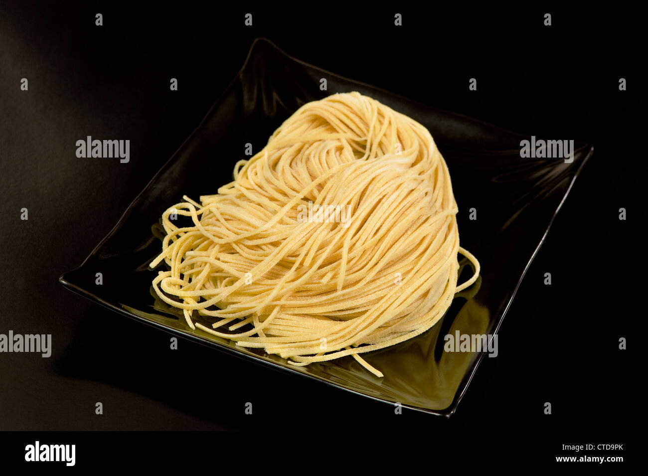 Raw spaghetti homemade Stock Photo - Alamy