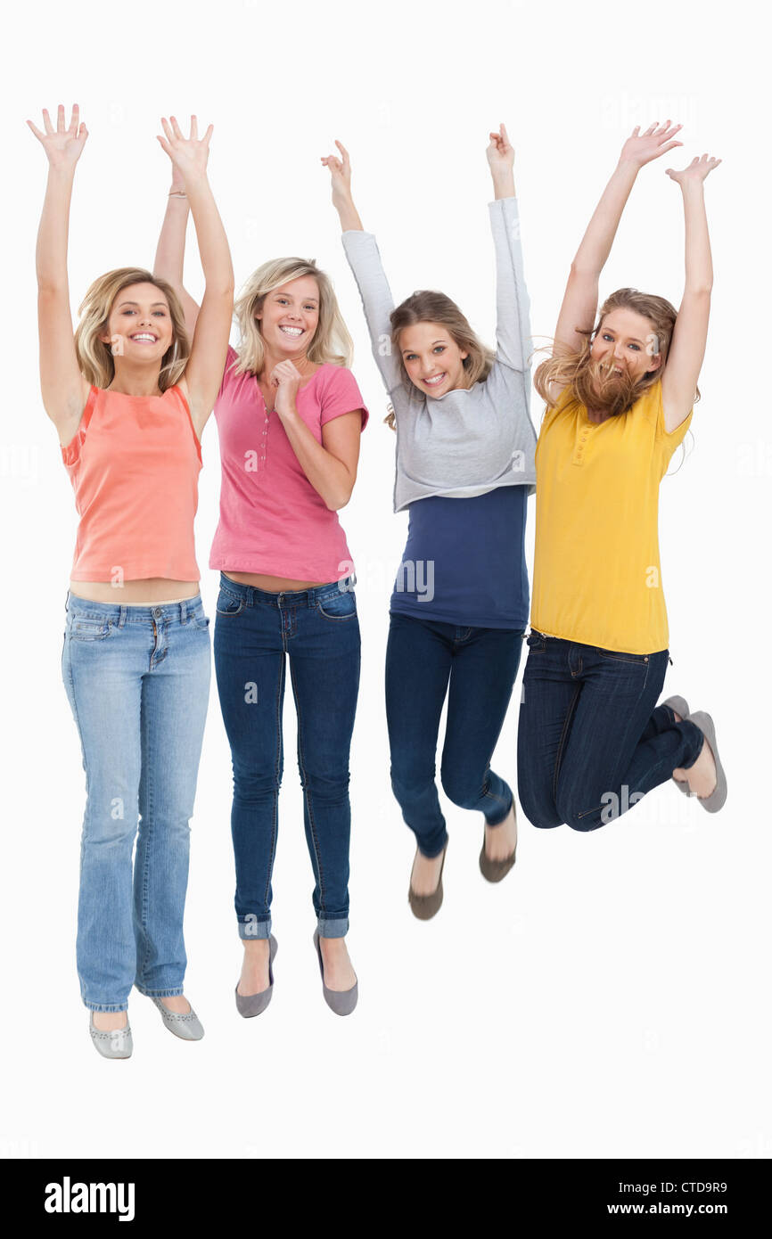 Smiling celebrating girls jumping up Stock Photo - Alamy