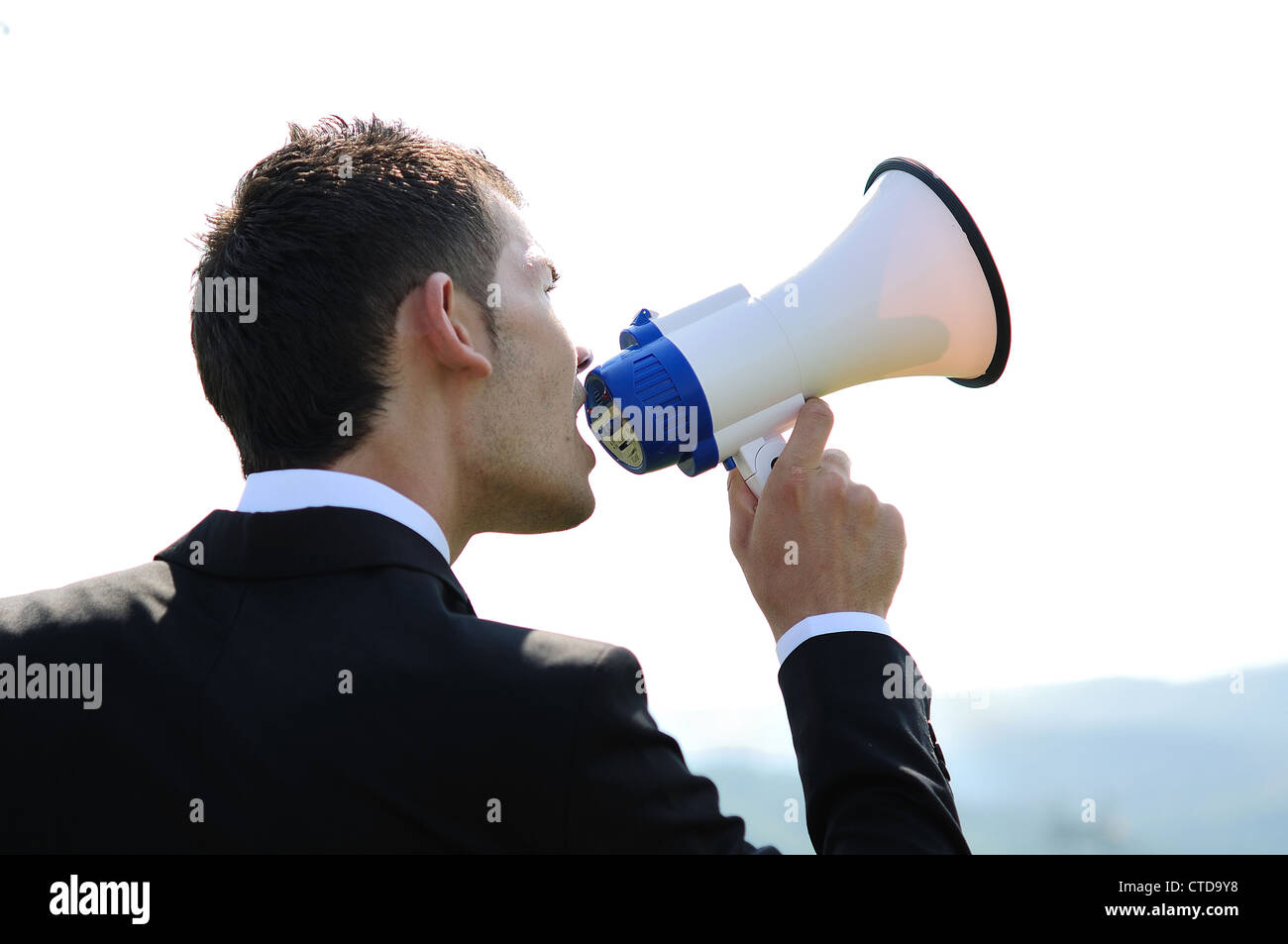 Business man with loudspeaker outside Stock Photo - Alamy