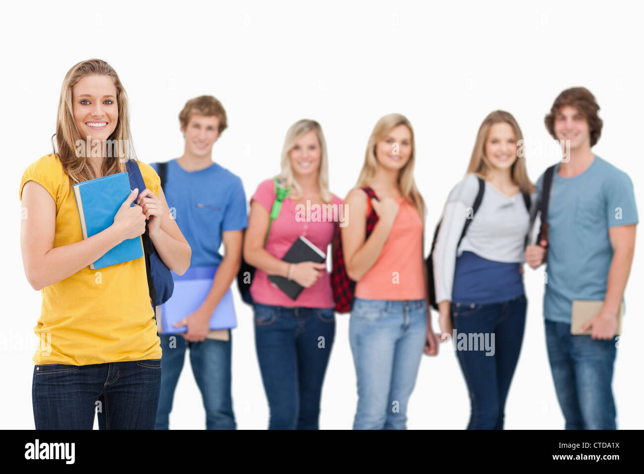 A group of college students standing as one girl stands in front of ...
