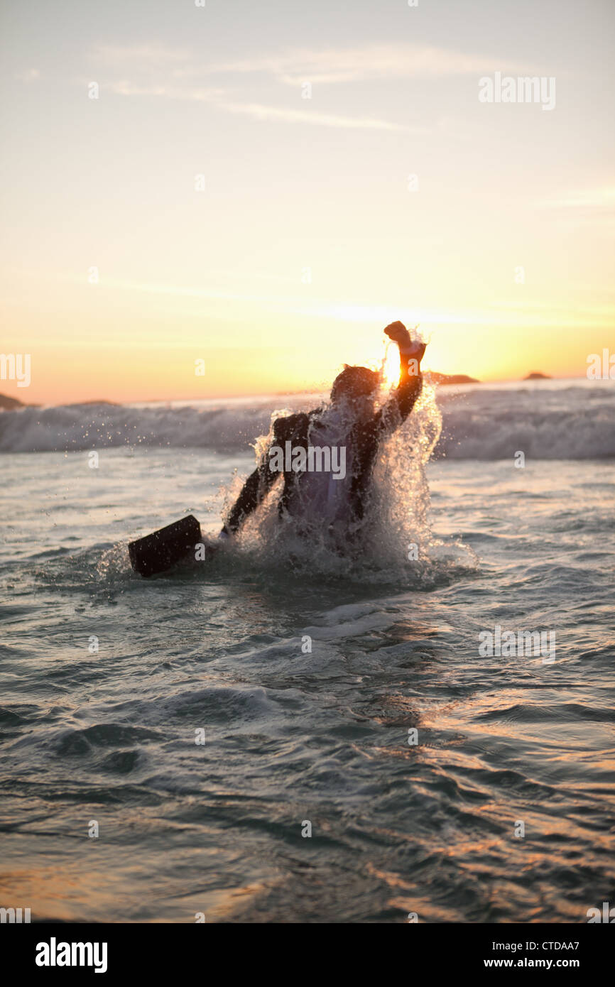 Young businessman getting in the water Stock Photo - Alamy