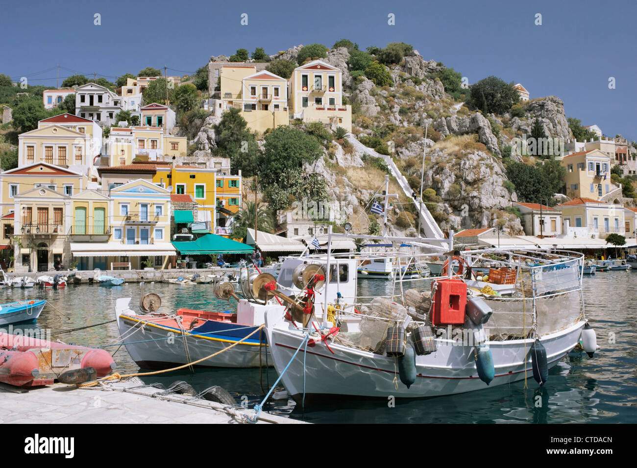 View of Rhodes harbor with fishing boat Stock Photo - Alamy