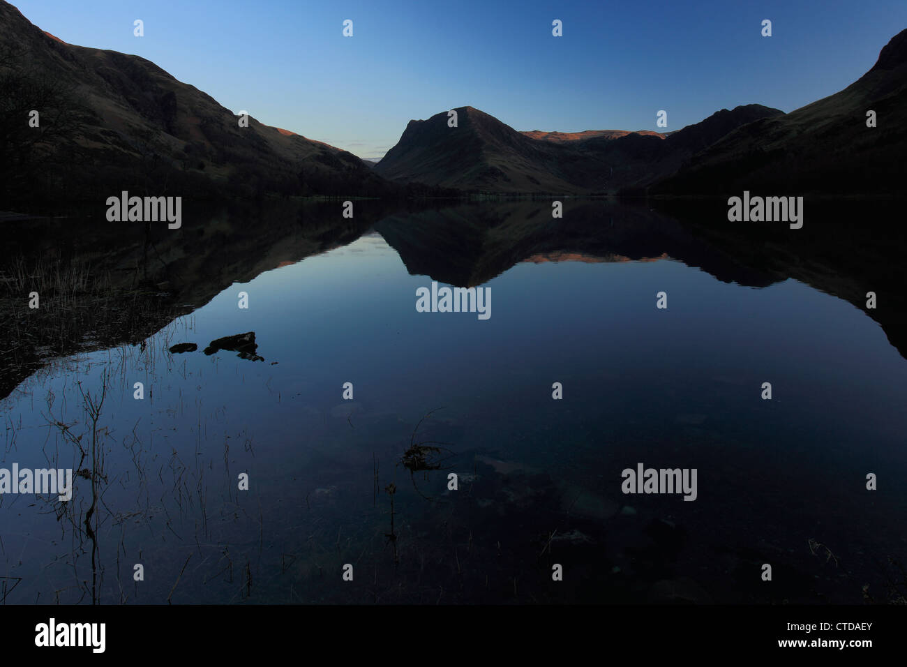 Sunset Autumn colours Fleetwith Pike fell, reflected in Buttermere ...