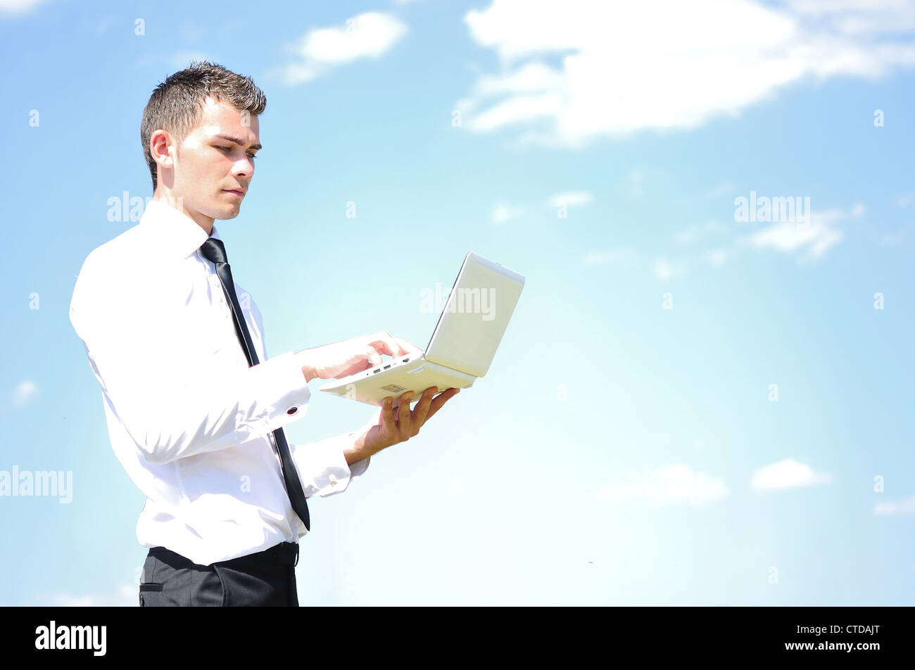 Business man with notebook on sky Stock Photo - Alamy