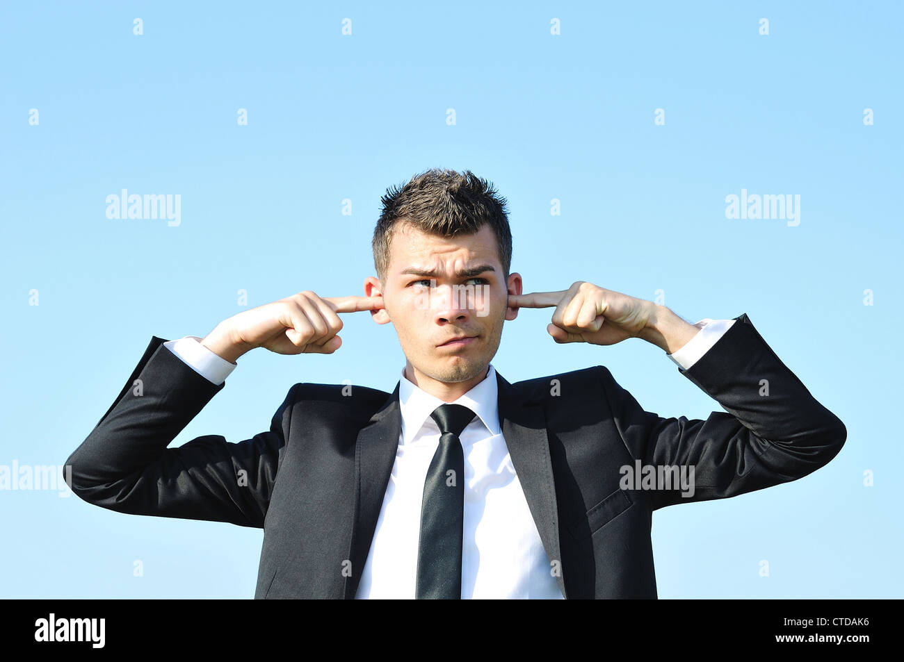Business man finger in ears hi-res stock photography and images - Alamy