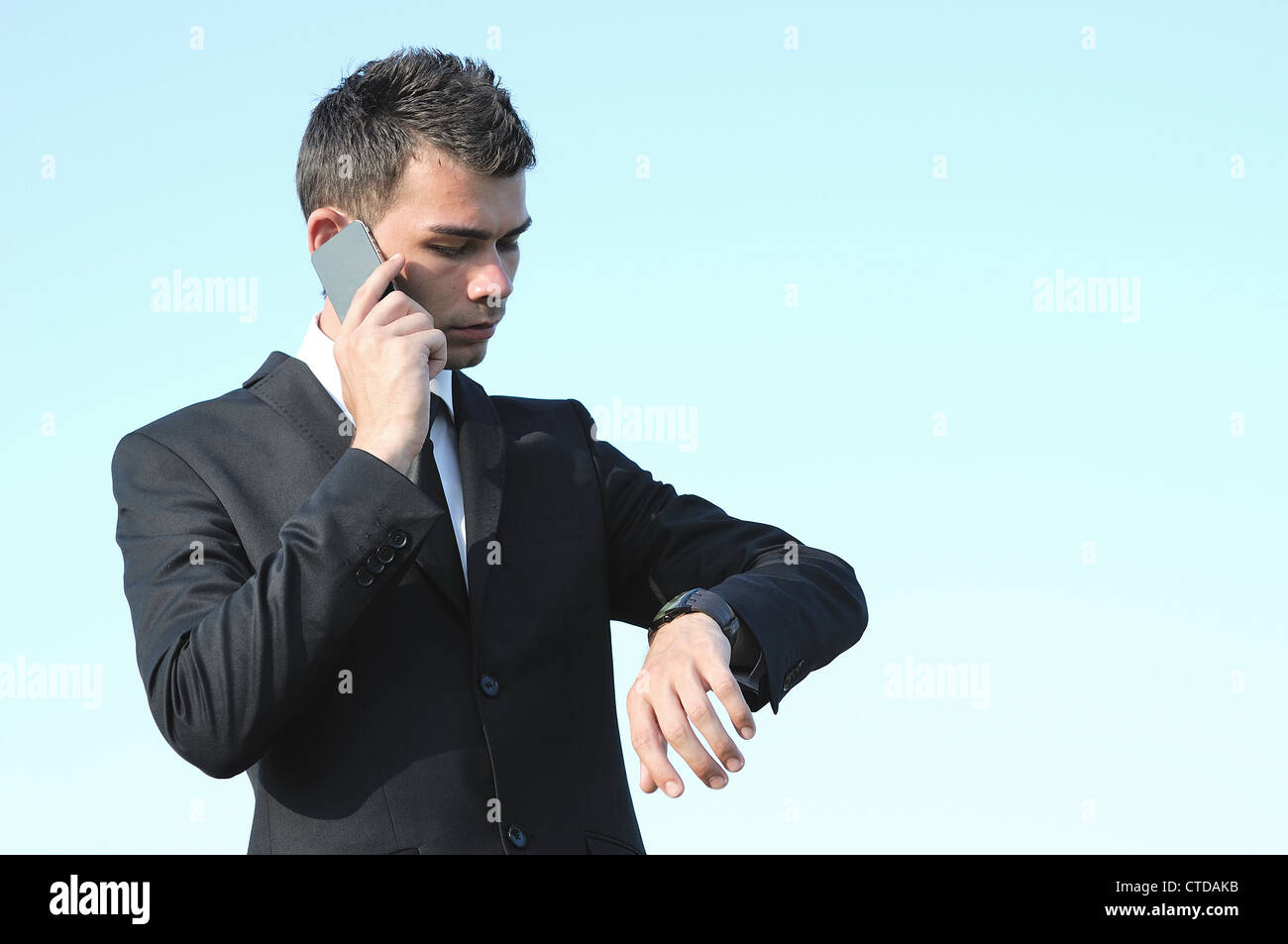 Business man looking at watch Stock Photo - Alamy
