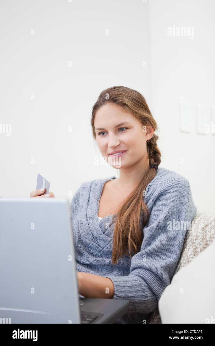 Woman sitting while using a computer Stock Photo - Alamy