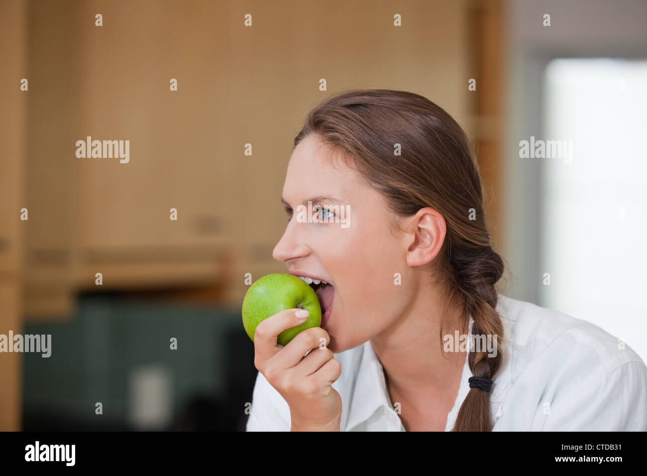 Woman eating an apple Stock Photo - Alamy