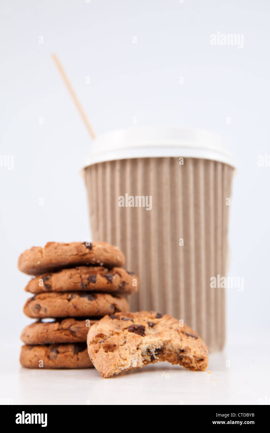 Five cookies and an half eaten cookie and a cup of coffee placed ...