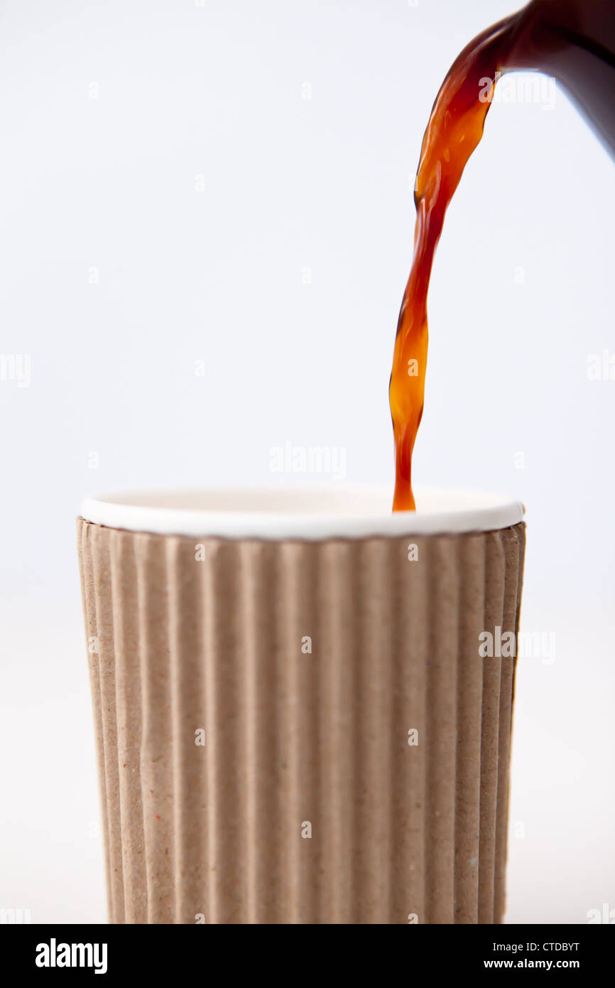 Paper cup being filled with coffee Stock Photo - Alamy