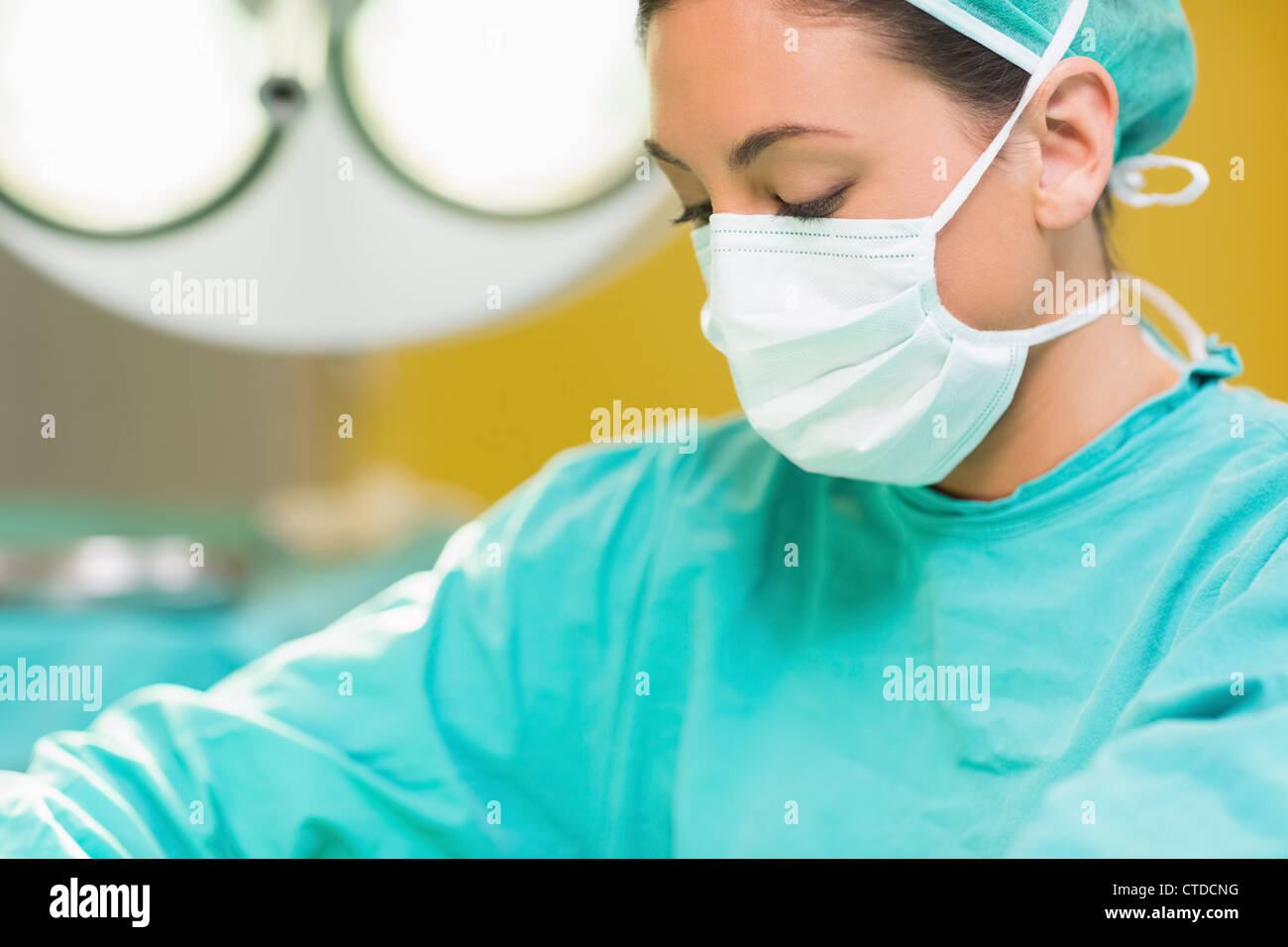 Serious female surgeon wearing a mask Stock Photo - Alamy