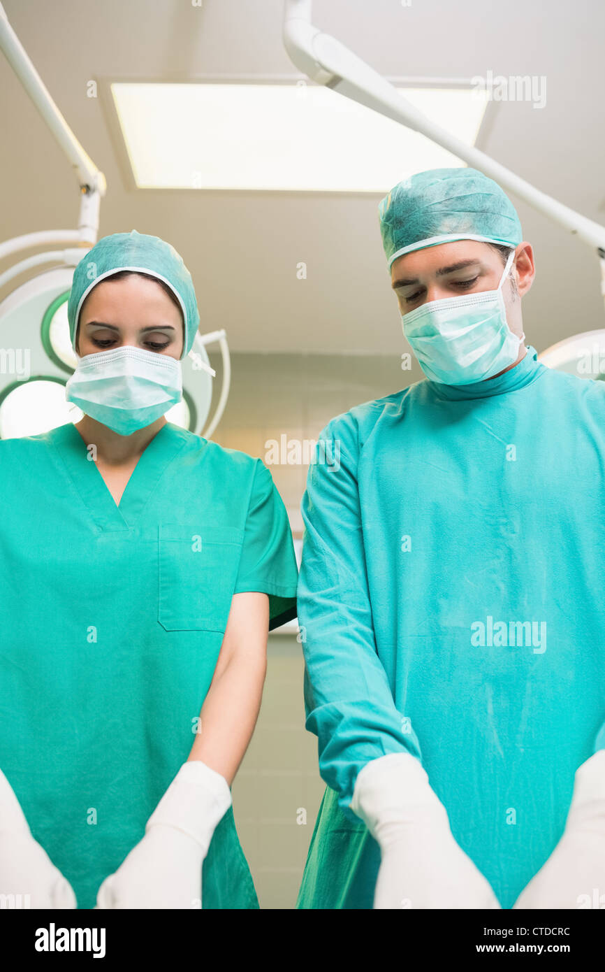 Surgeons standing while working Stock Photo - Alamy