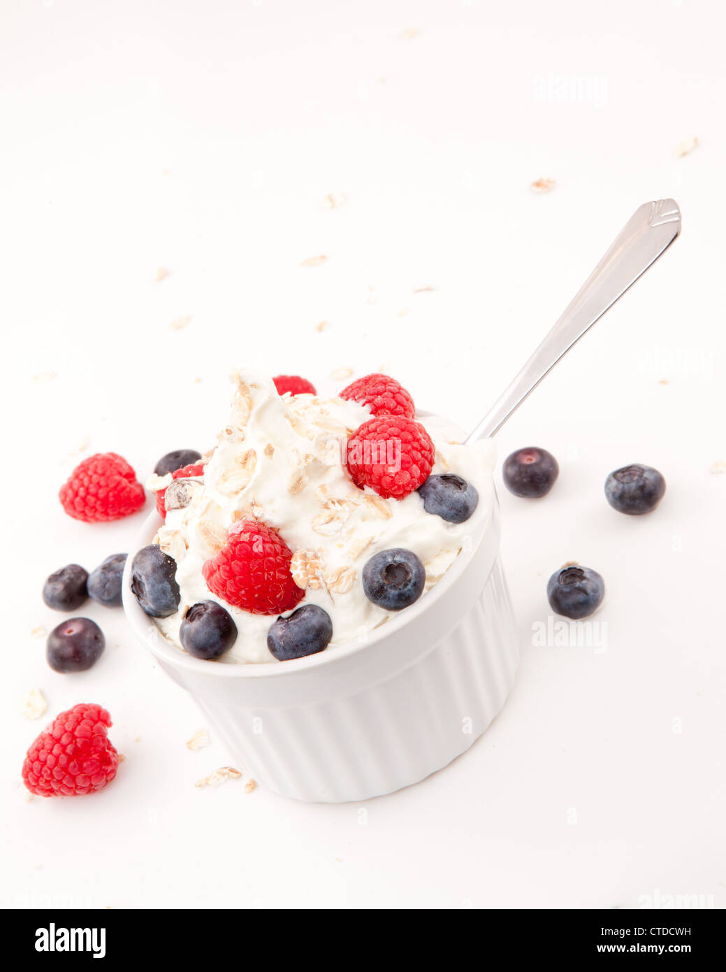 Whipped cream mix with berries and spoon Stock Photo - Alamy
