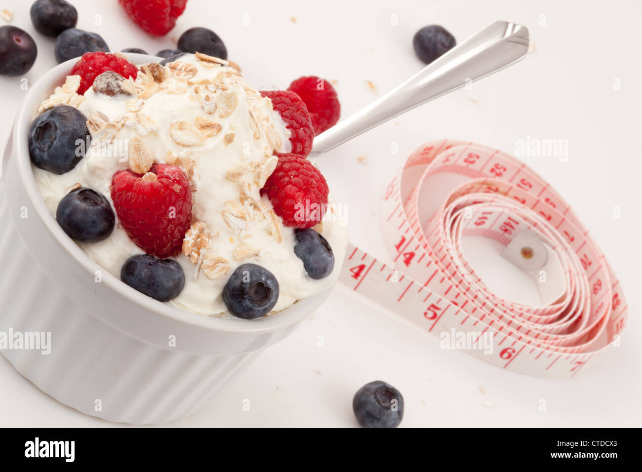 Jar of fruits and whipped cream with spoon and tape measure Stock Photo ...