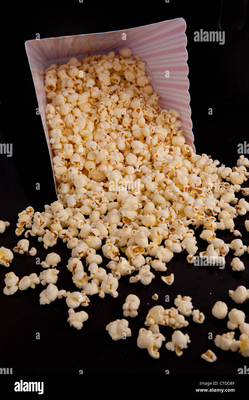 Many pop corn falling out of a box Stock Photo - Alamy
