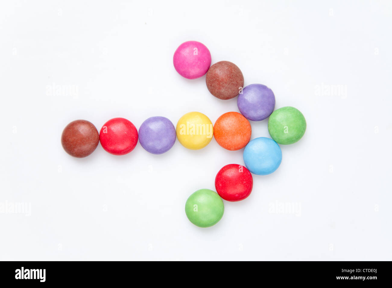 Arrow of candies Stock Photo - Alamy