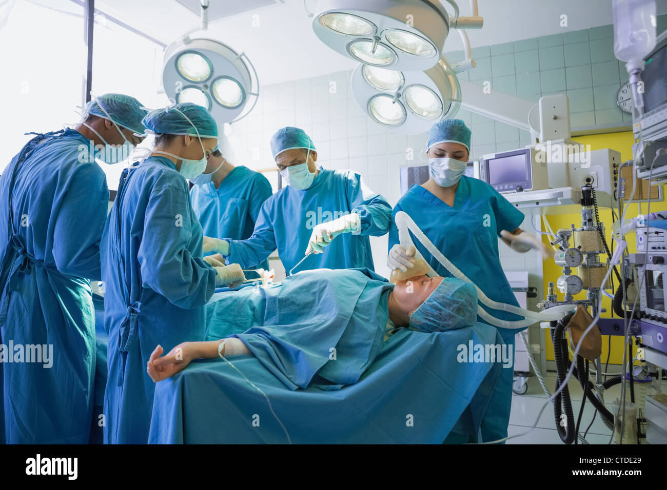 Group of surgeons operating an unconscious patient Stock Photo - Alamy