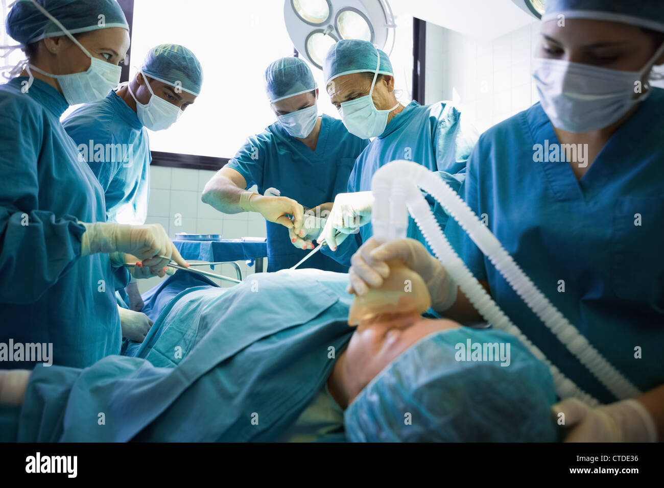 Unconscious patient being operated by a team of surgeons Stock Photo ...