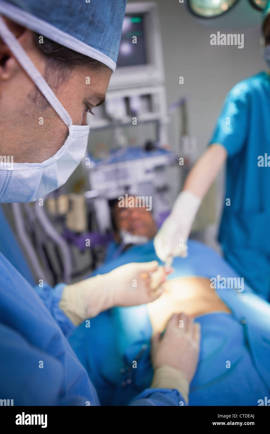 Surgeon with surgical scissors in his hand Stock Photo - Alamy