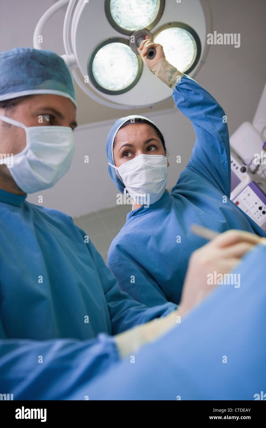 Two surgeons under surgical lights Stock Photo - Alamy