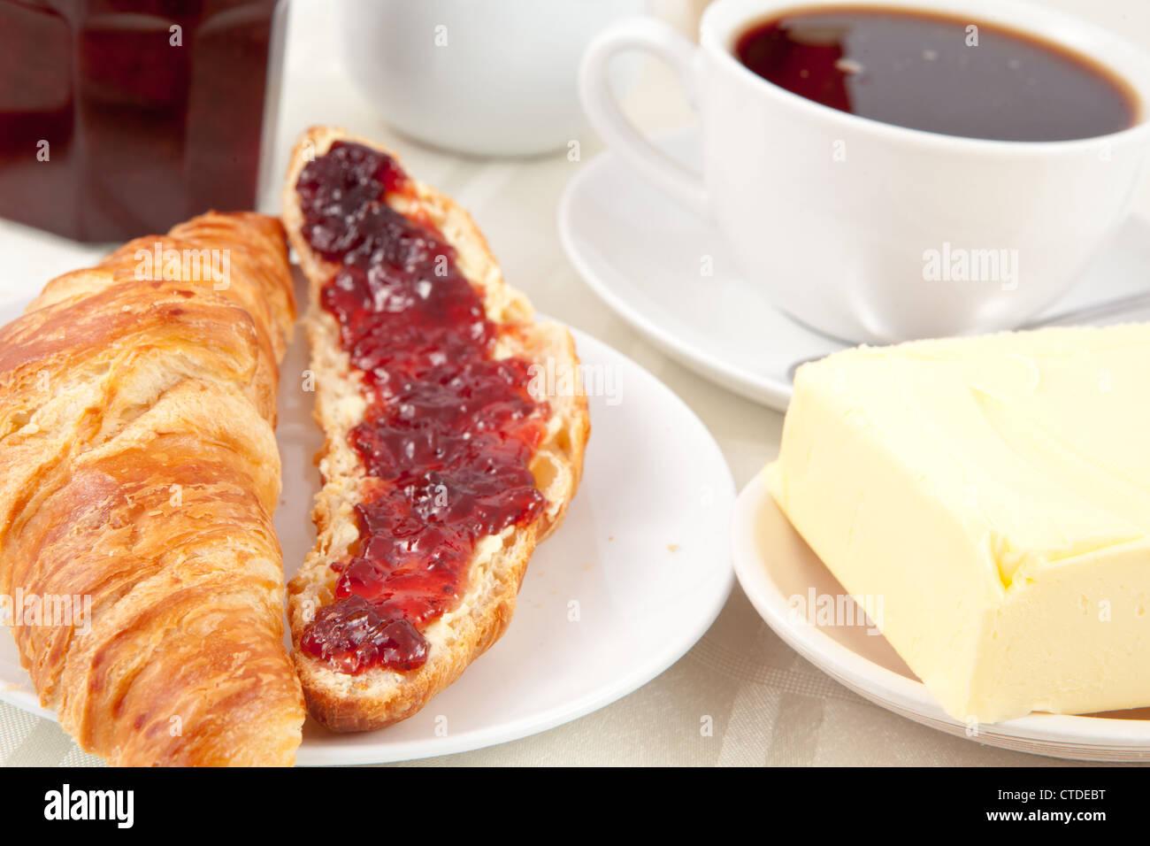Breakfast with a croissant spread with jam Stock Photo - Alamy