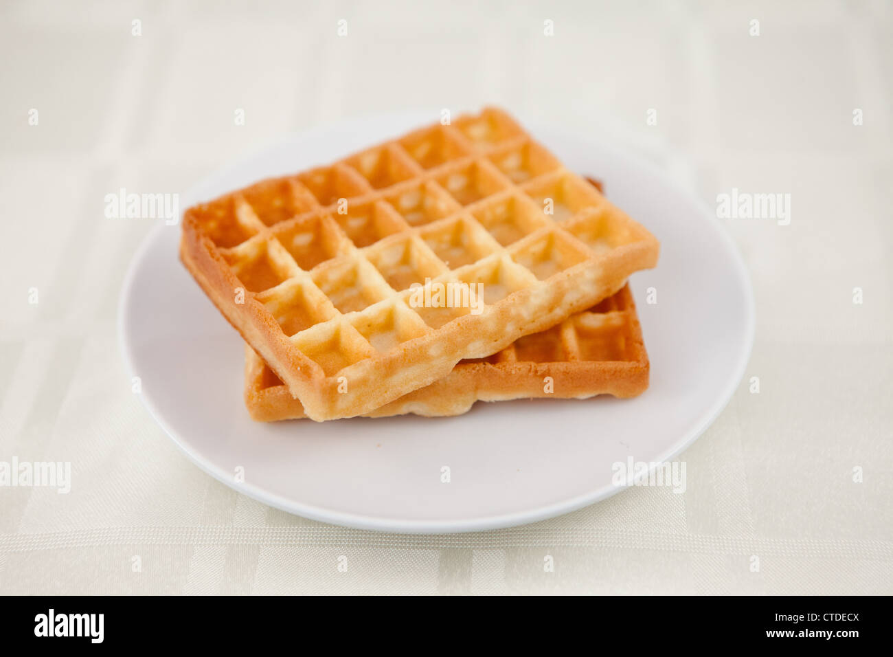 Two waffles on a saucer Stock Photo - Alamy