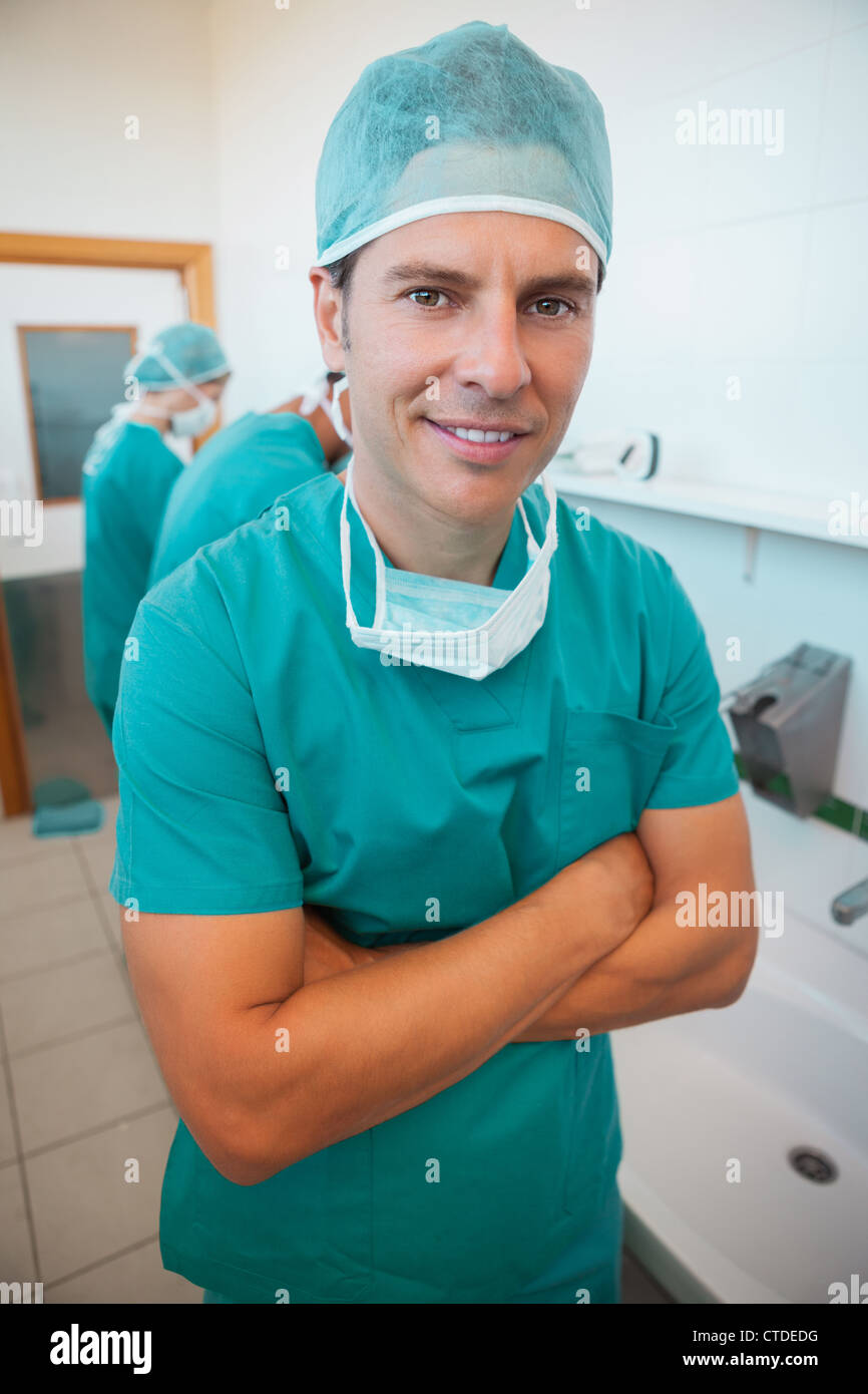 Smiling surgeon with his arms folded Stock Photo - Alamy