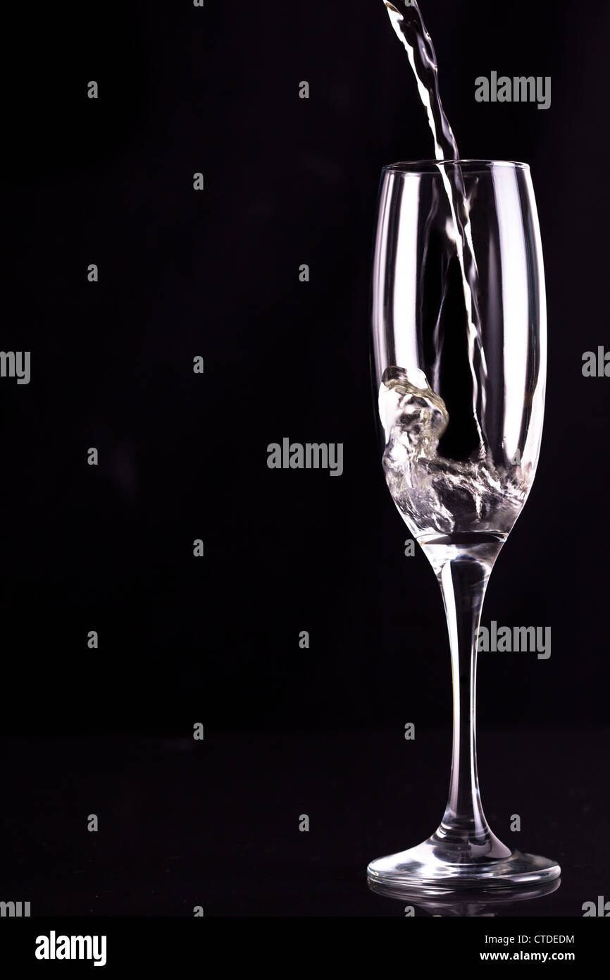 Empty champagne flute being filled Stock Photo - Alamy