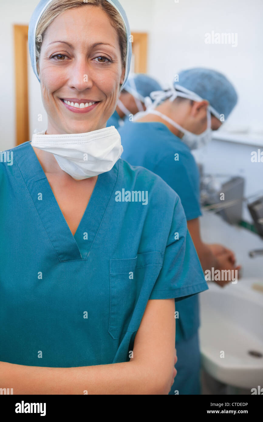 Smiling female surgeon with his arms folded Stock Photo - Alamy
