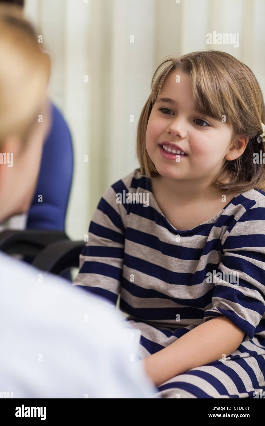 Cute girl sitting in a waiting room Stock Photo - Alamy