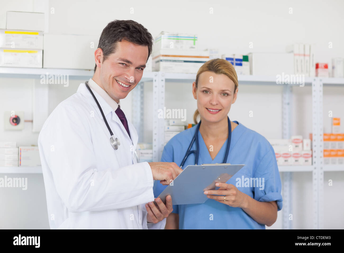 Smiling pharmacist with a nurse in a pharmacy Stock Photo - Alamy