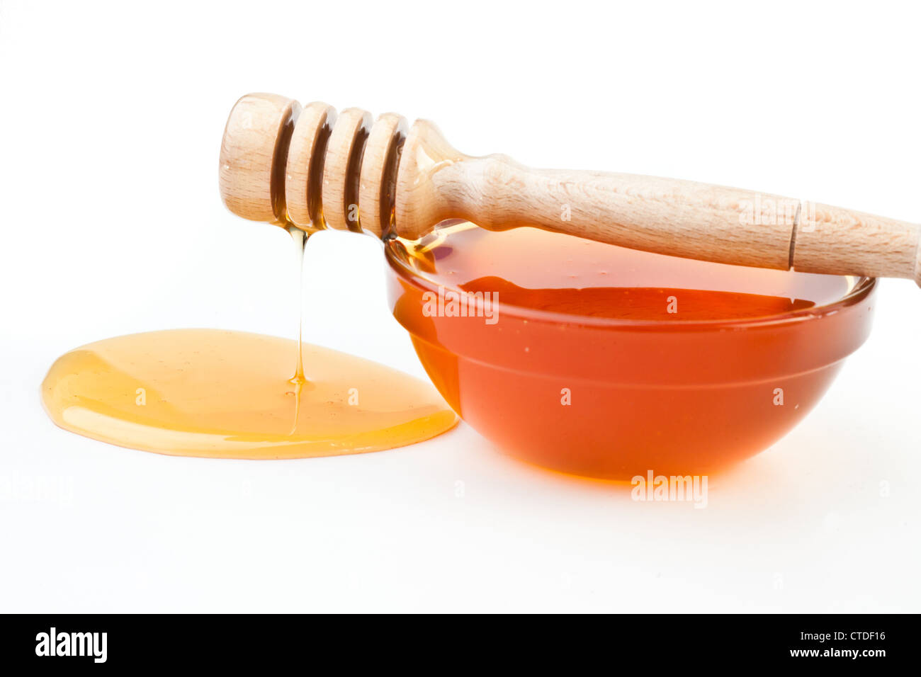 Thin honey trickle spilling on the floor Stock Photo - Alamy