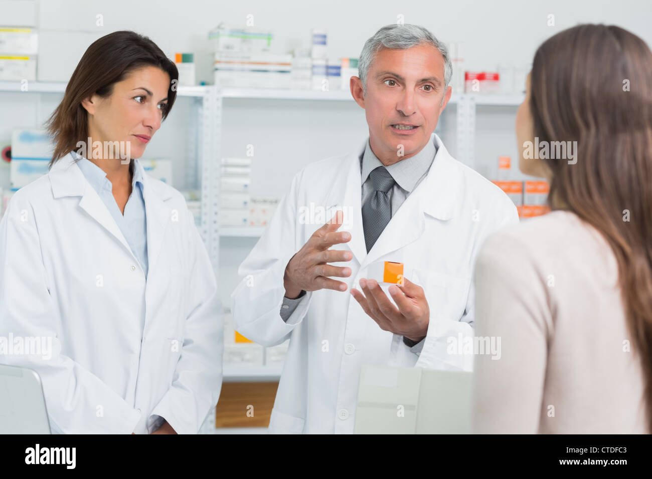 Male pharmacist talking woman hi-res stock photography and images - Alamy