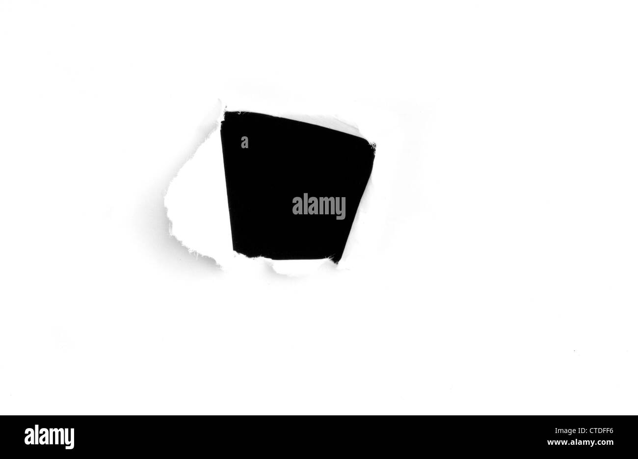 Small hole in paper Stock Photo - Alamy