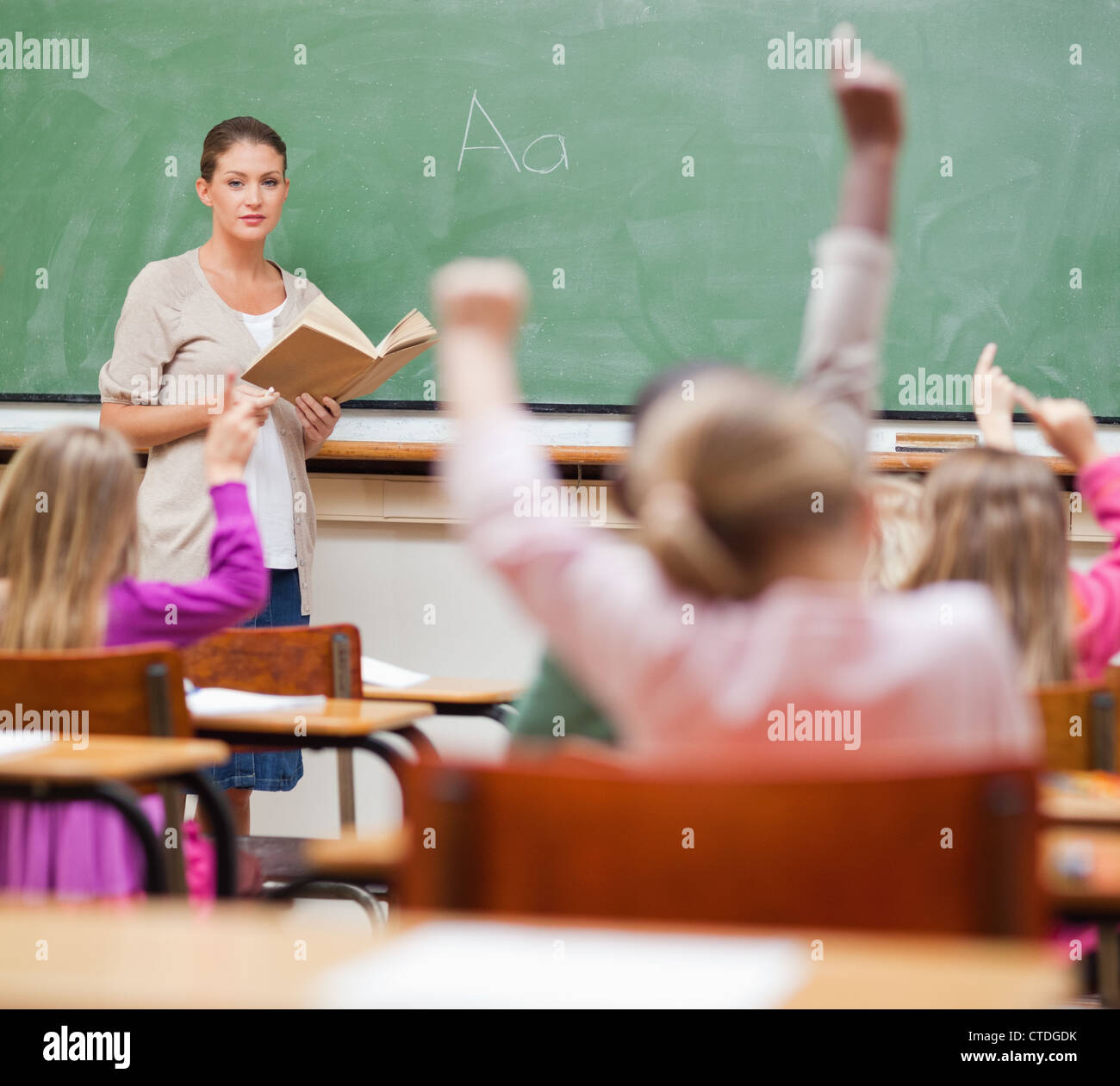 Teacher about to call on one of her students Stock Photo - Alamy