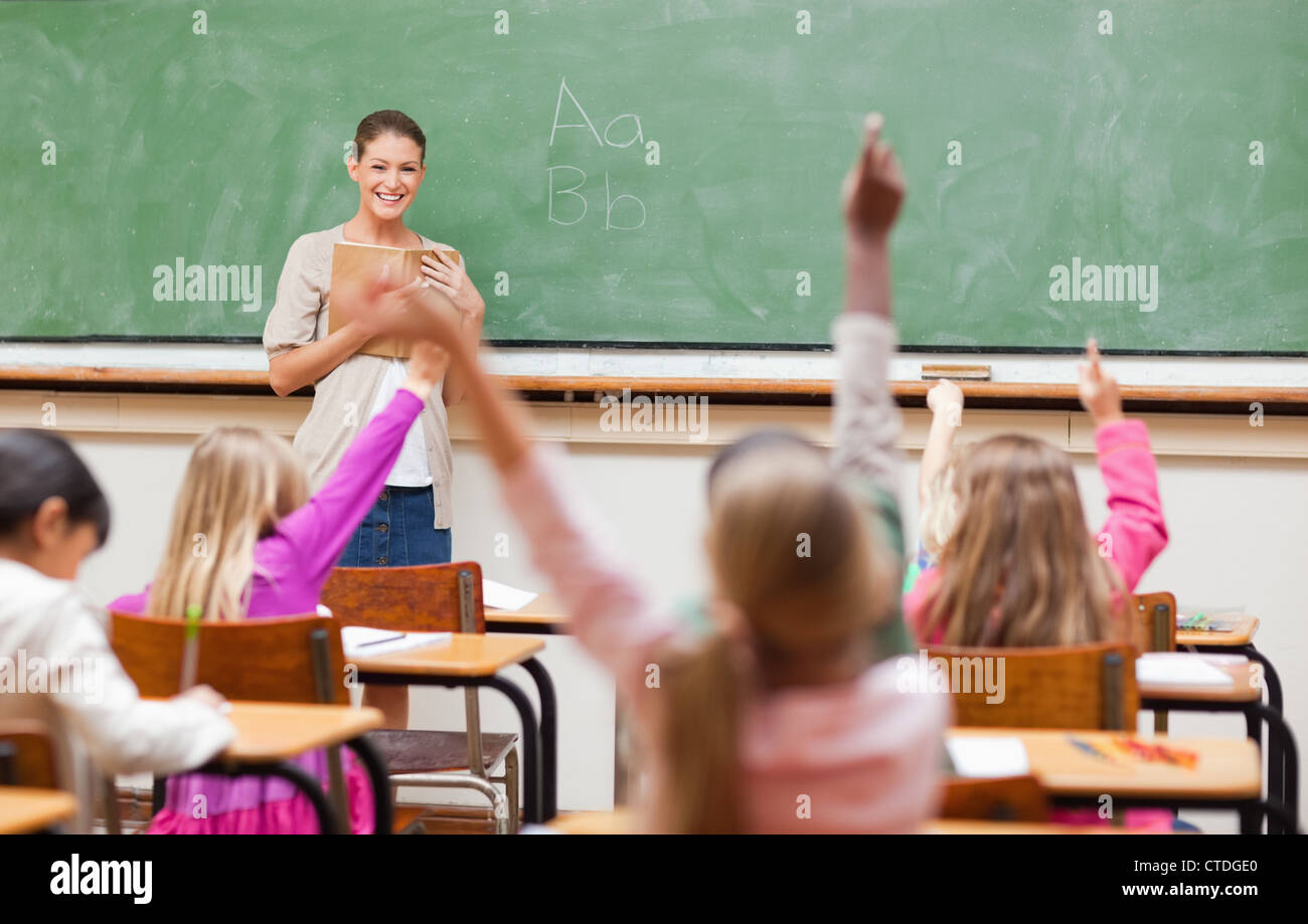 Smiling teacher giving lesson Stock Photo - Alamy