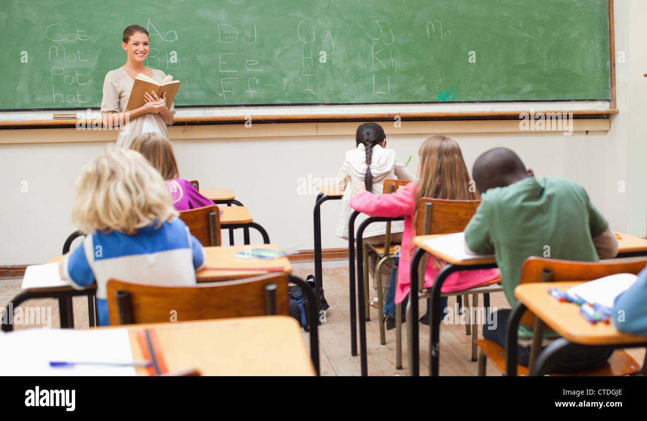 Back view of elementary students during lesson Stock Photo - Alamy