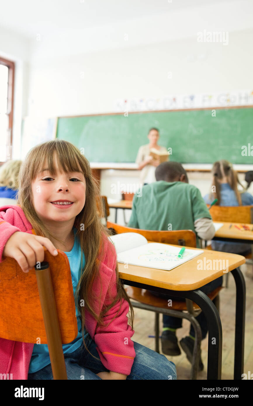 Girl turned around during lesson Stock Photo - Alamy