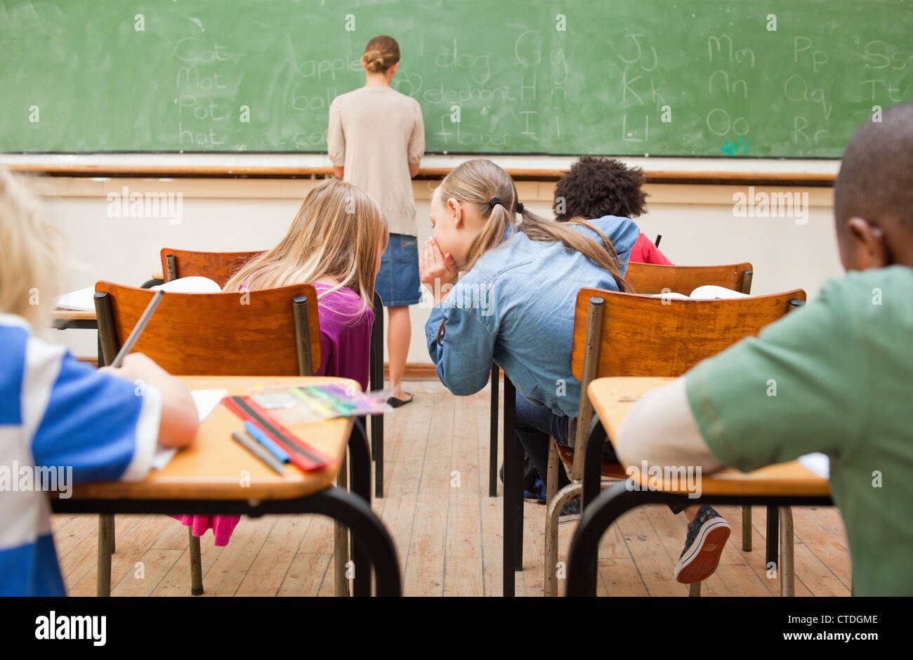 Schoolgirls talking during class Stock Photo - Alamy