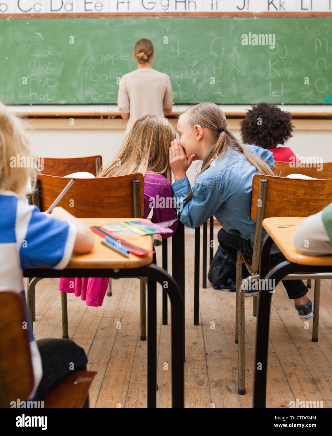 Schoolchildren whispering class hi-res stock photography and images - Alamy