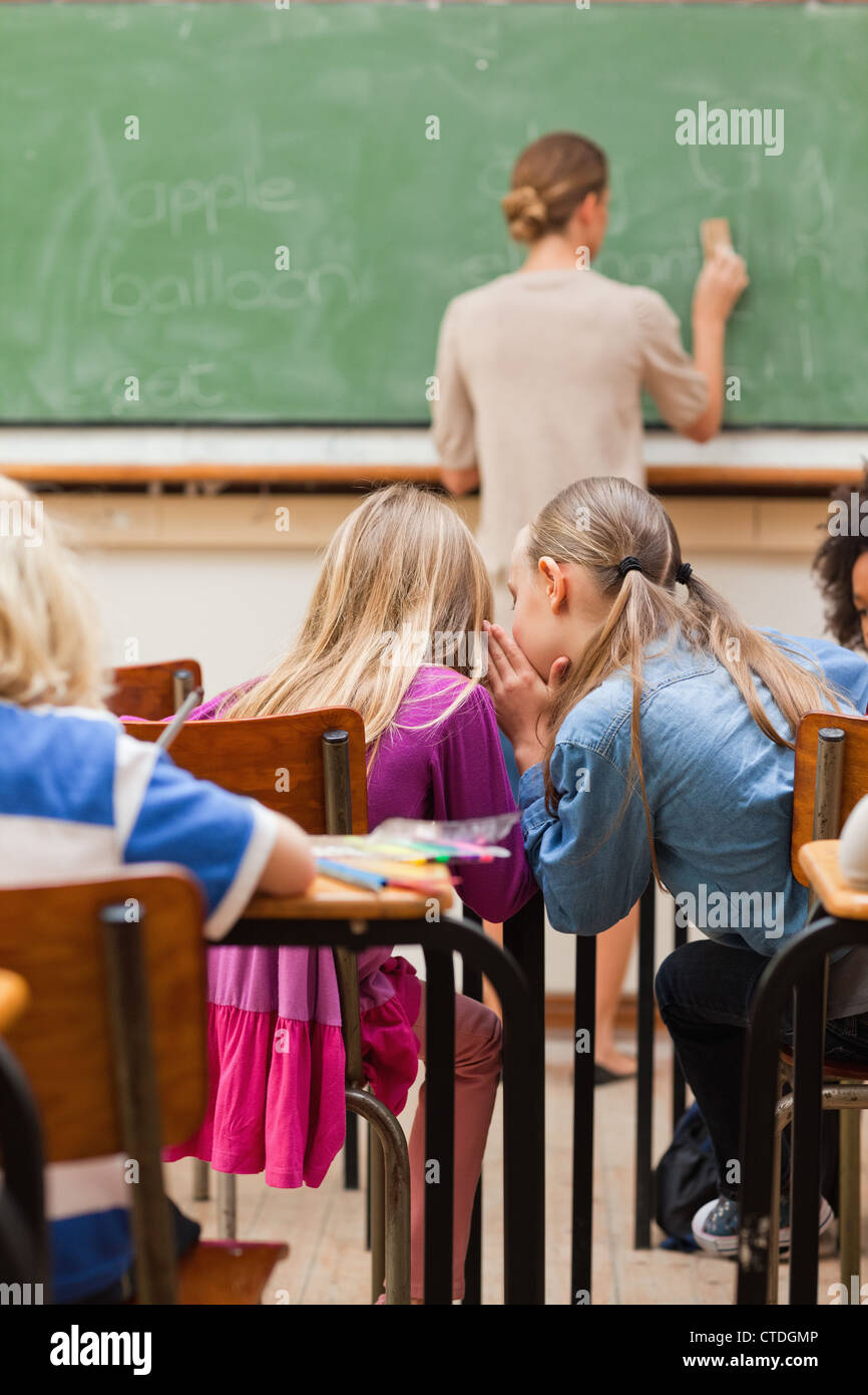 Back view of girls talking during class Stock Photo - Alamy