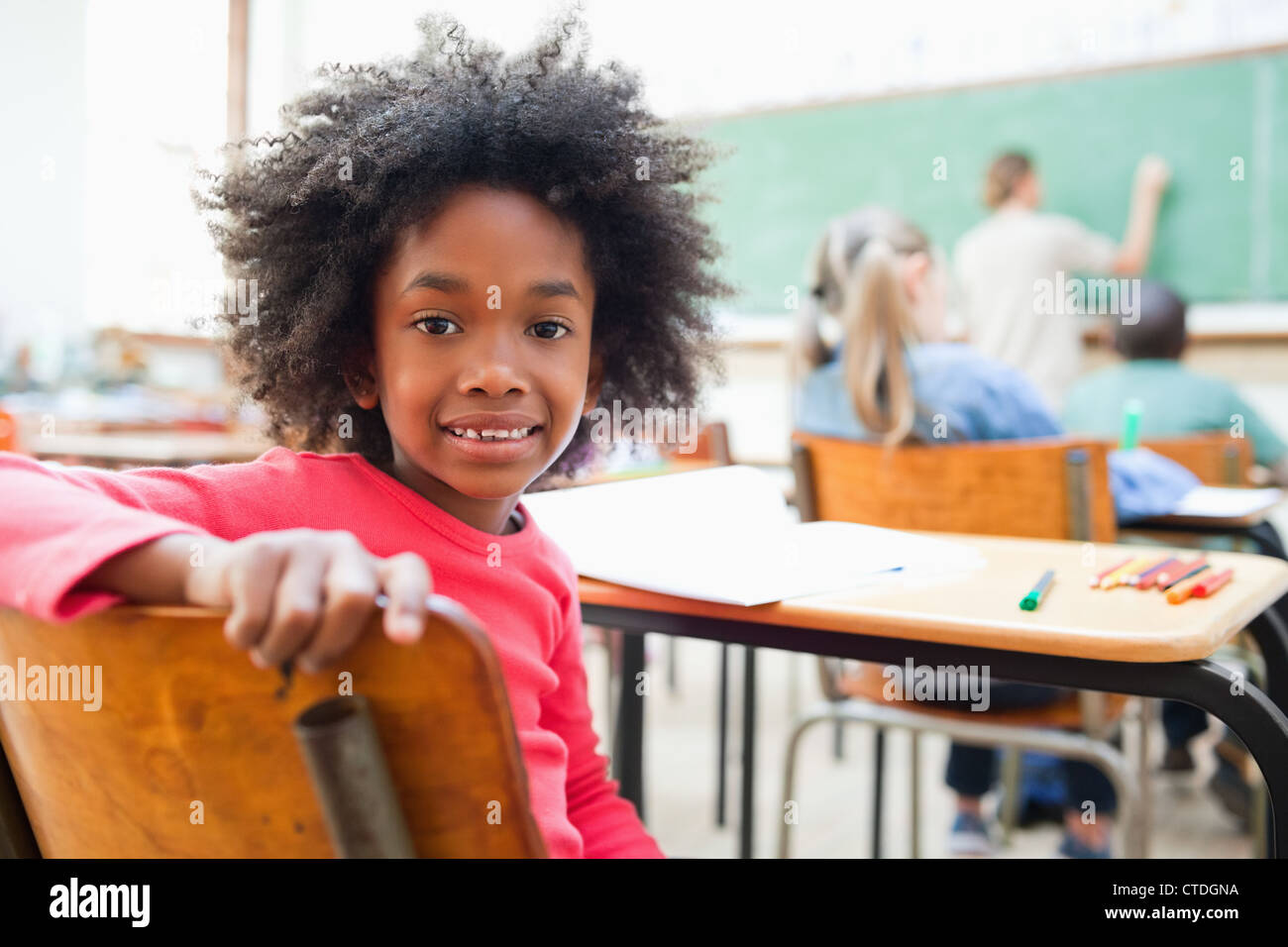 Schoolgirl turned around during class Stock Photo - Alamy