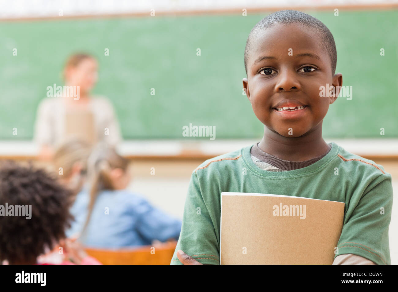 Pupil standing in classroom Stock Photo - Alamy
