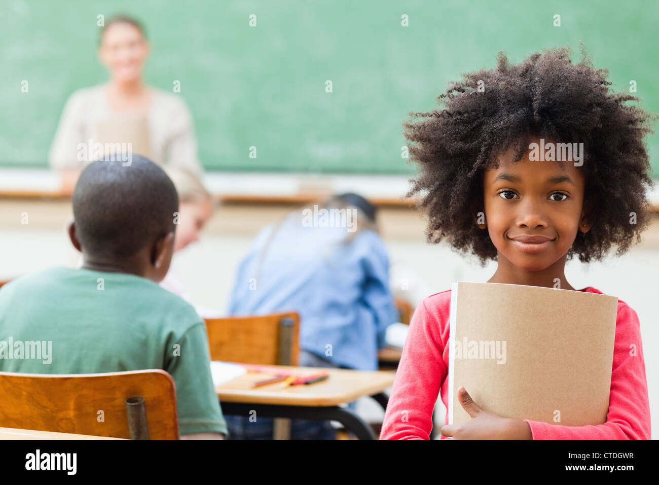 Girl standing in classroom Stock Photo - Alamy
