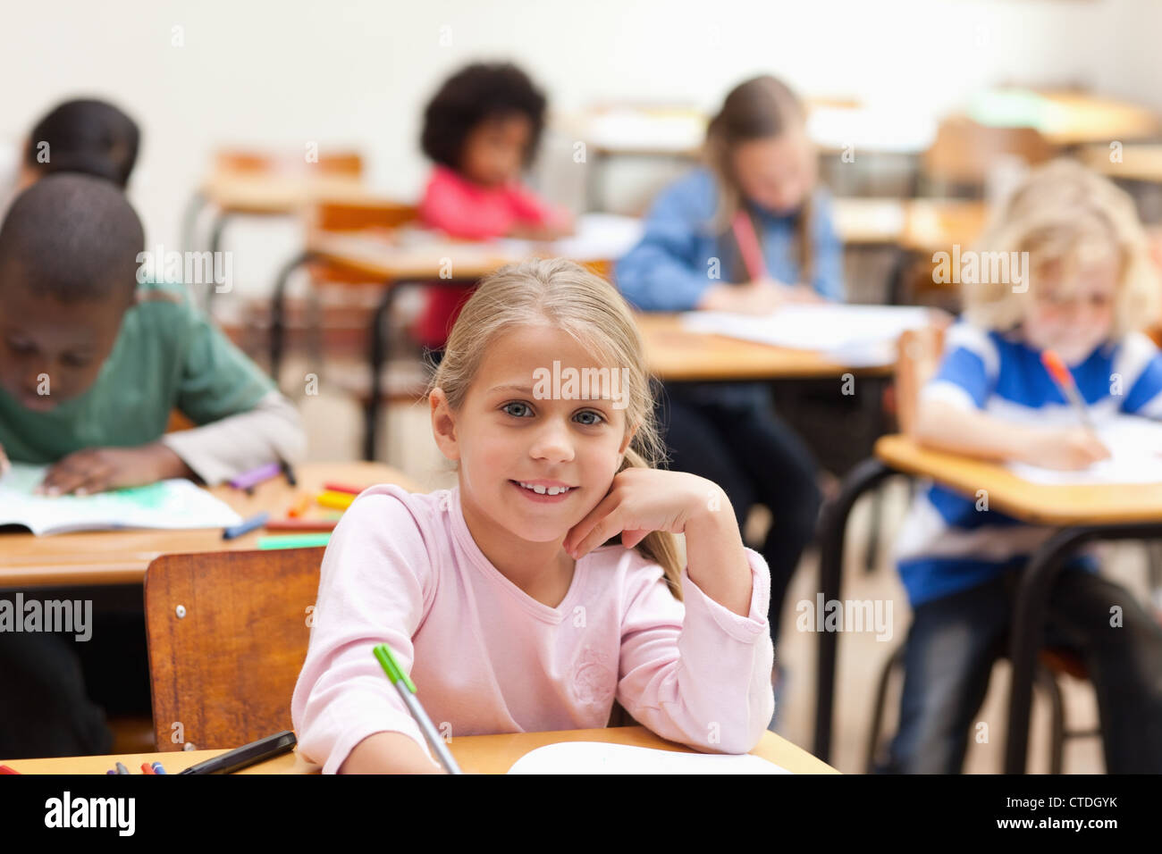 Smiling girl sitting in the classroom Stock Photo - Alamy