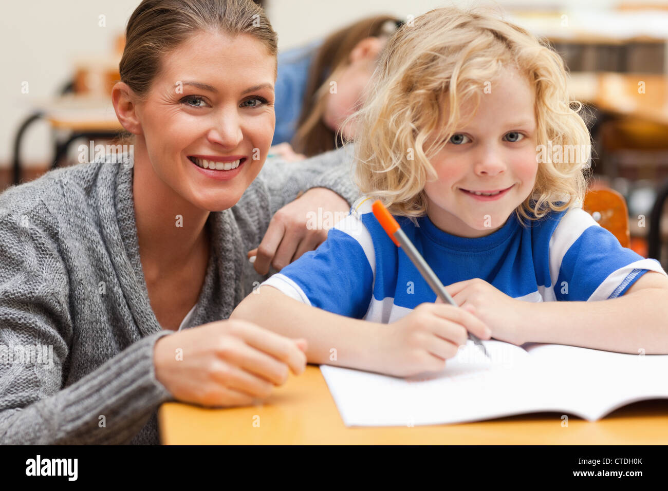 Student getting help from his teacher Stock Photo - Alamy