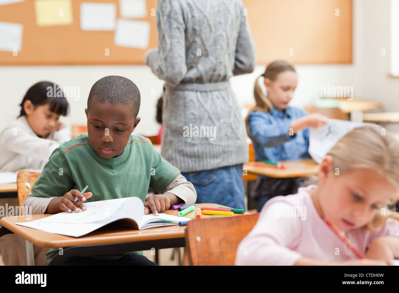 Teacher walking through classroom Stock Photo - Alamy