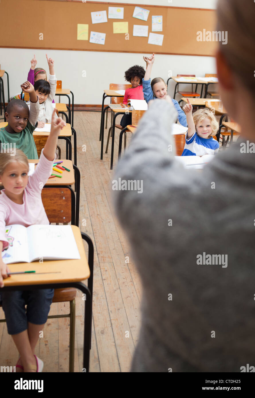 Teacher choosing one of her students to answer Stock Photo - Alamy