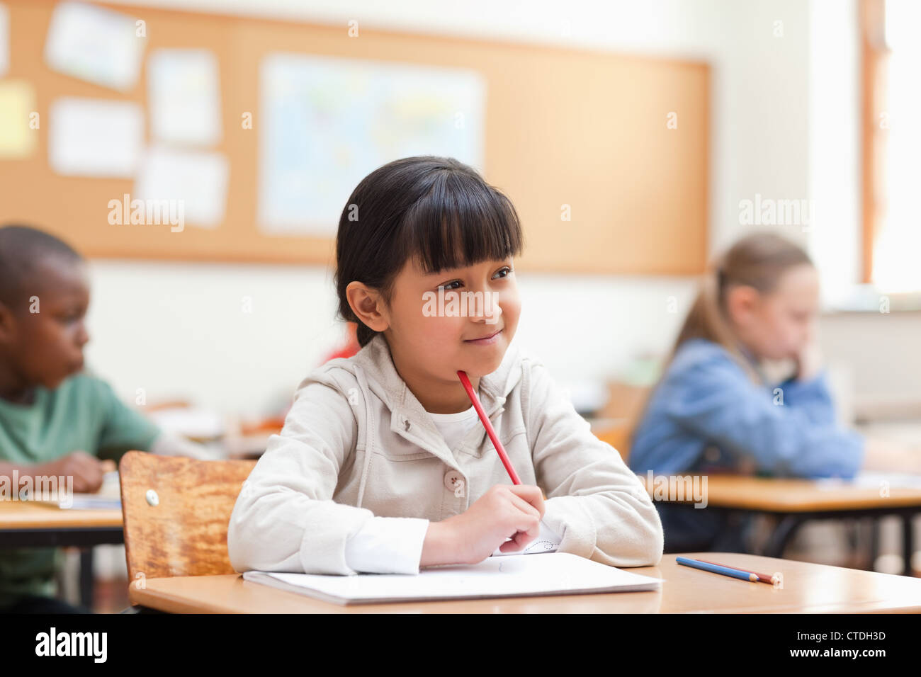 Girl sitting at her desk during class Stock Photo - Alamy